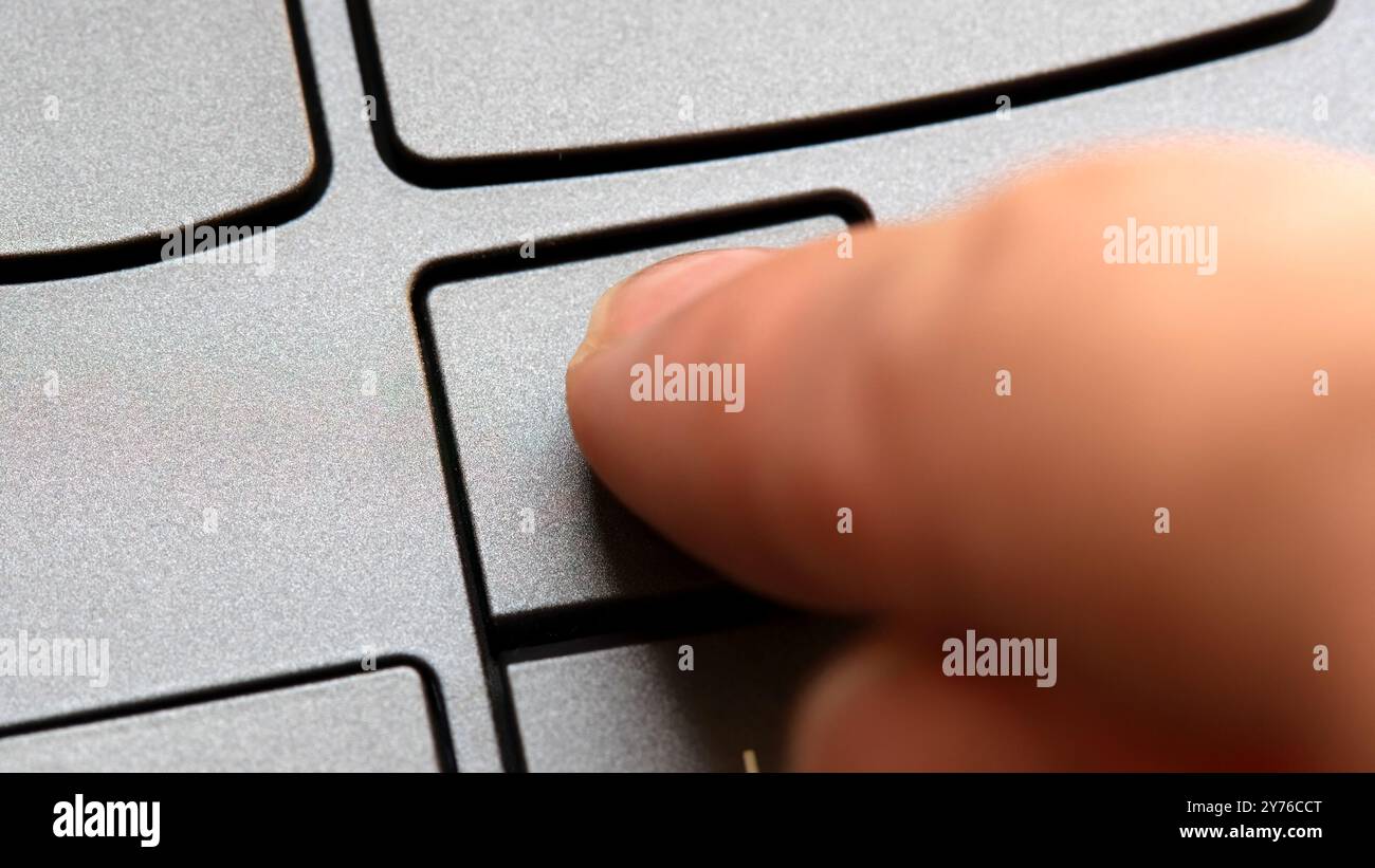 Man pressing the up arrow key on a modern laptop computer keyboard ...