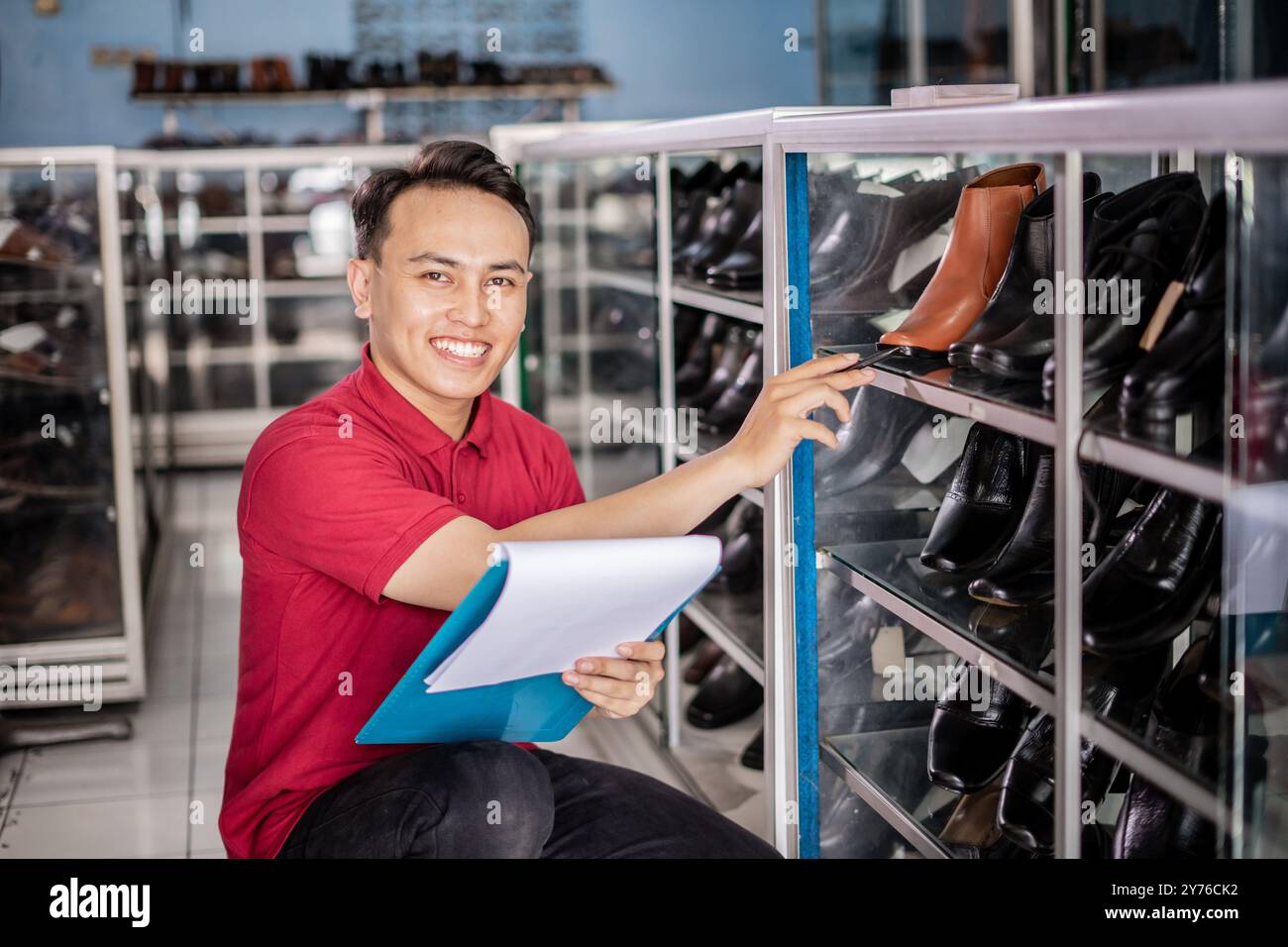professional employee pointing leather shoes and holding clipboard ...