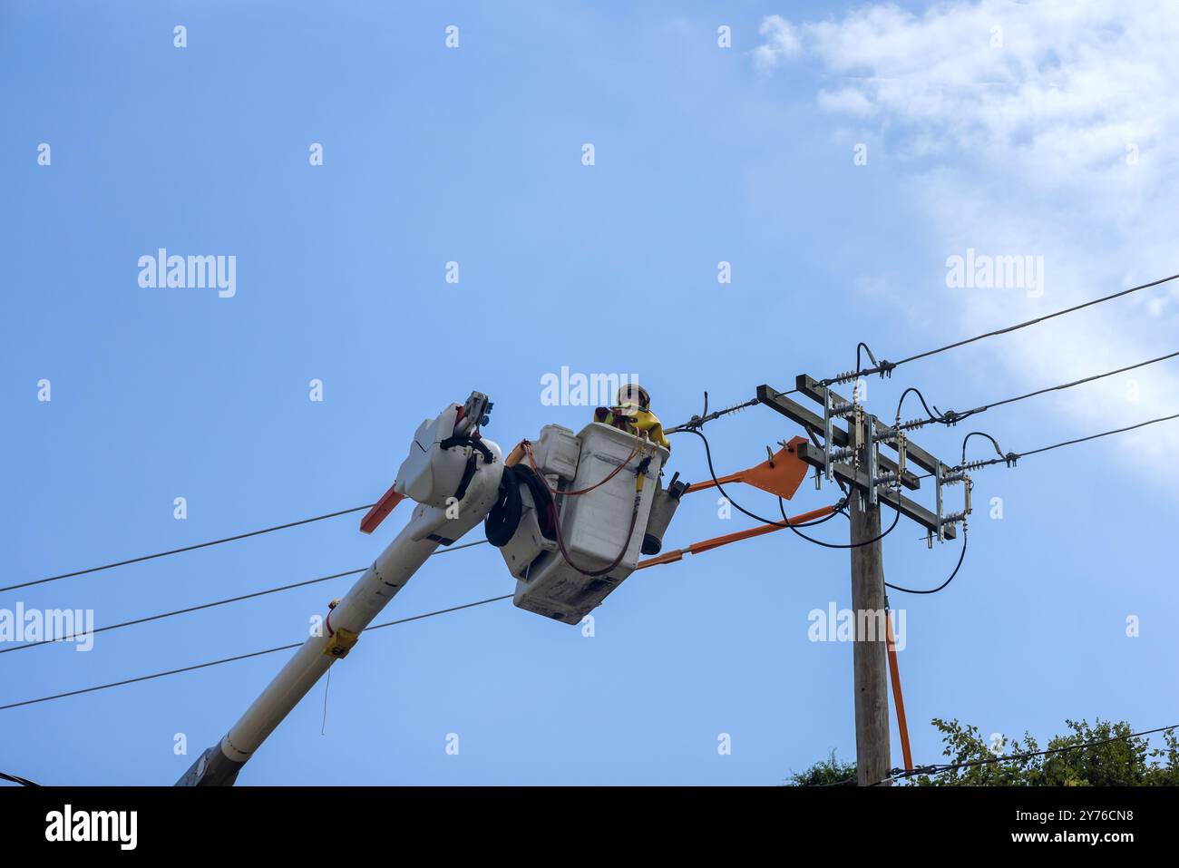 Using insulated equipment, lineman electrician engineer work at pole to ...