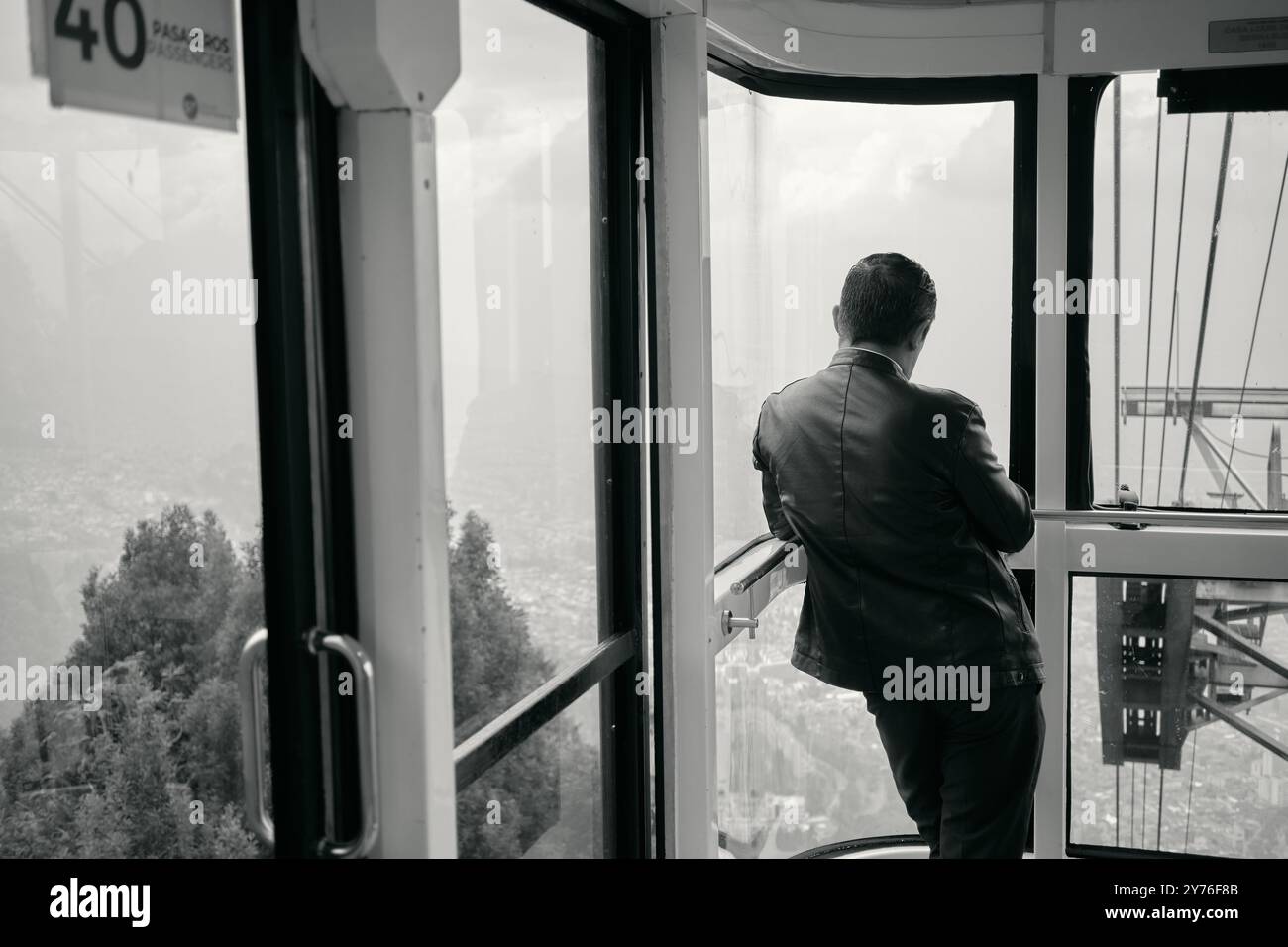 Man standing in teleferico for Cerro de Monserrate, Bogota, Colombia ...