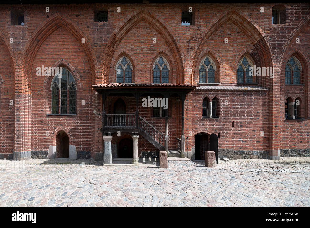 Elevated entrance to medieval structure covered with red tile awning ...
