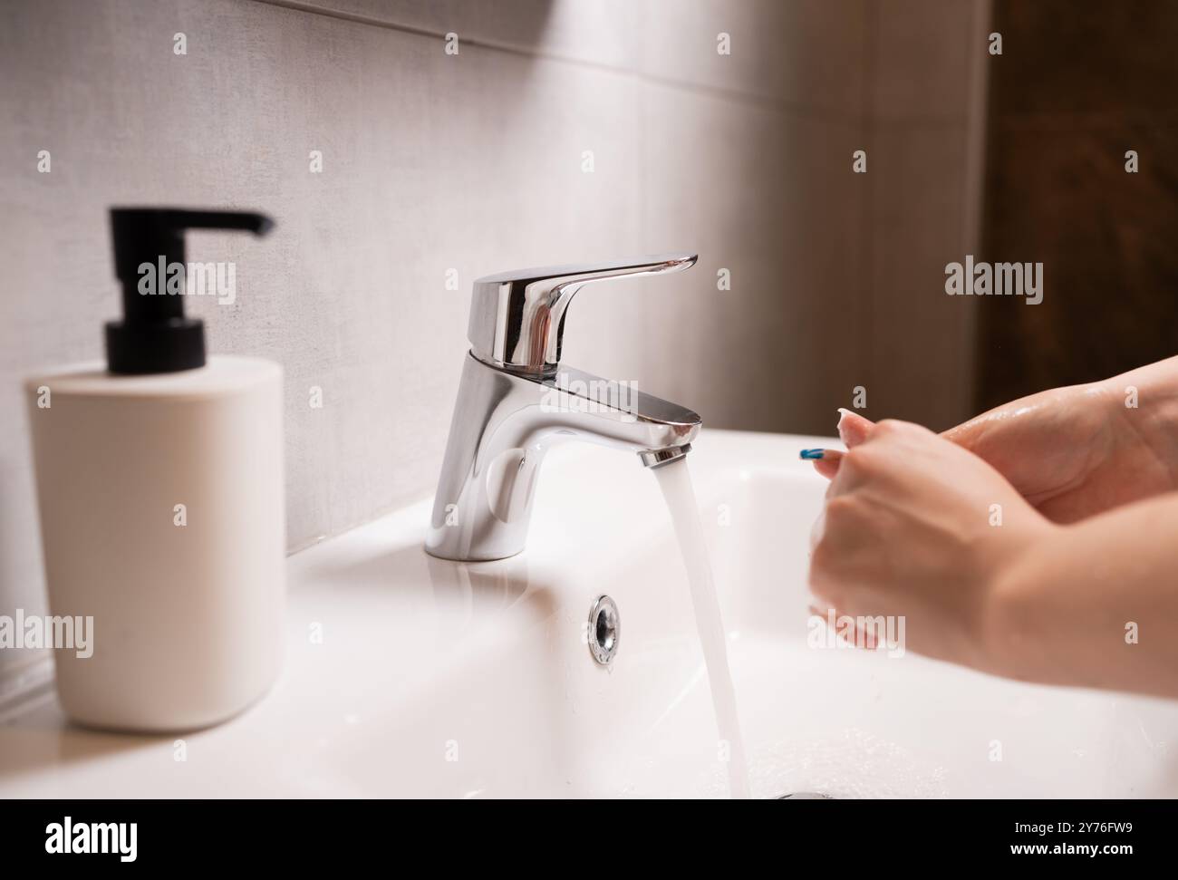 Hand washing. Women's hands wash their hands with soap under running ...