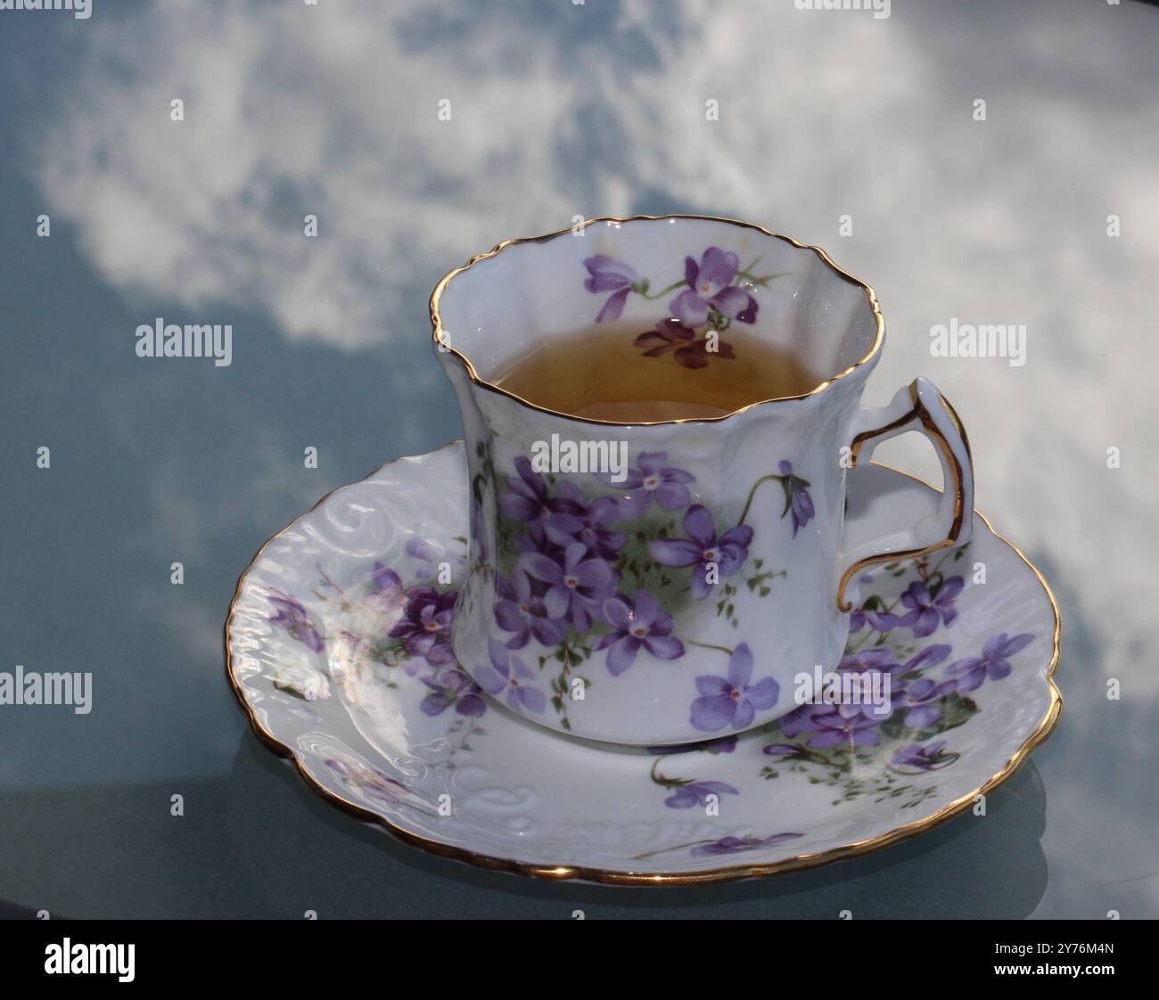 Reflections of Elegance: Antique Teacup Beneath the Clouds Stock Photo ...