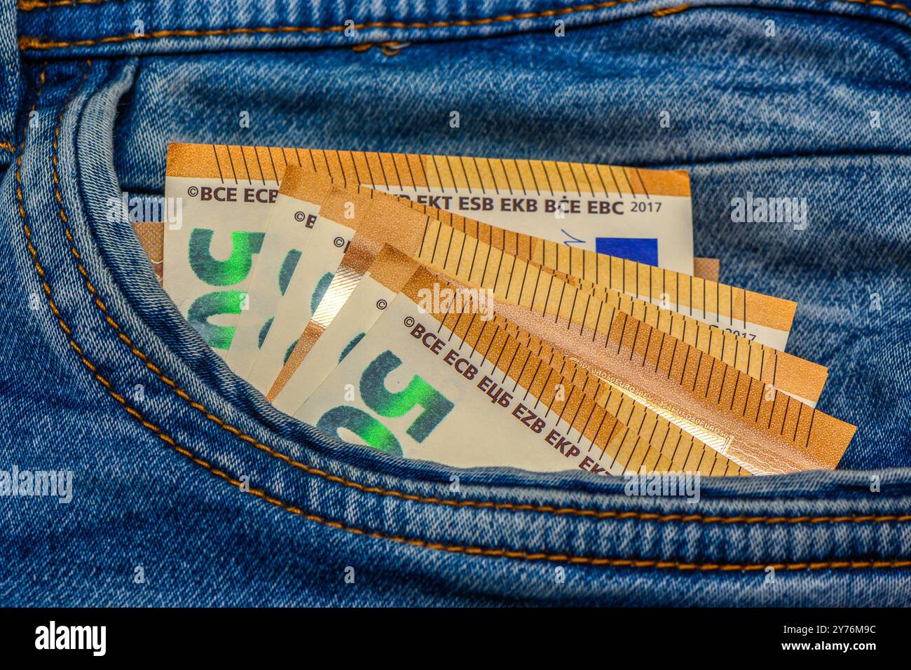 Euro in jeans pocket sticking out Stock Photo - Alamy