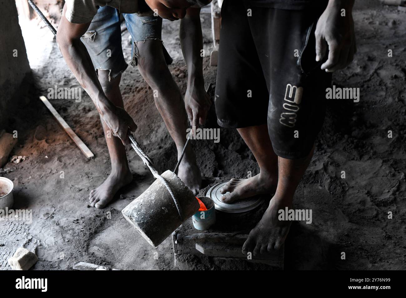 Ambatolampy, artisanal aluminium foundery. Worker with crucible with ...