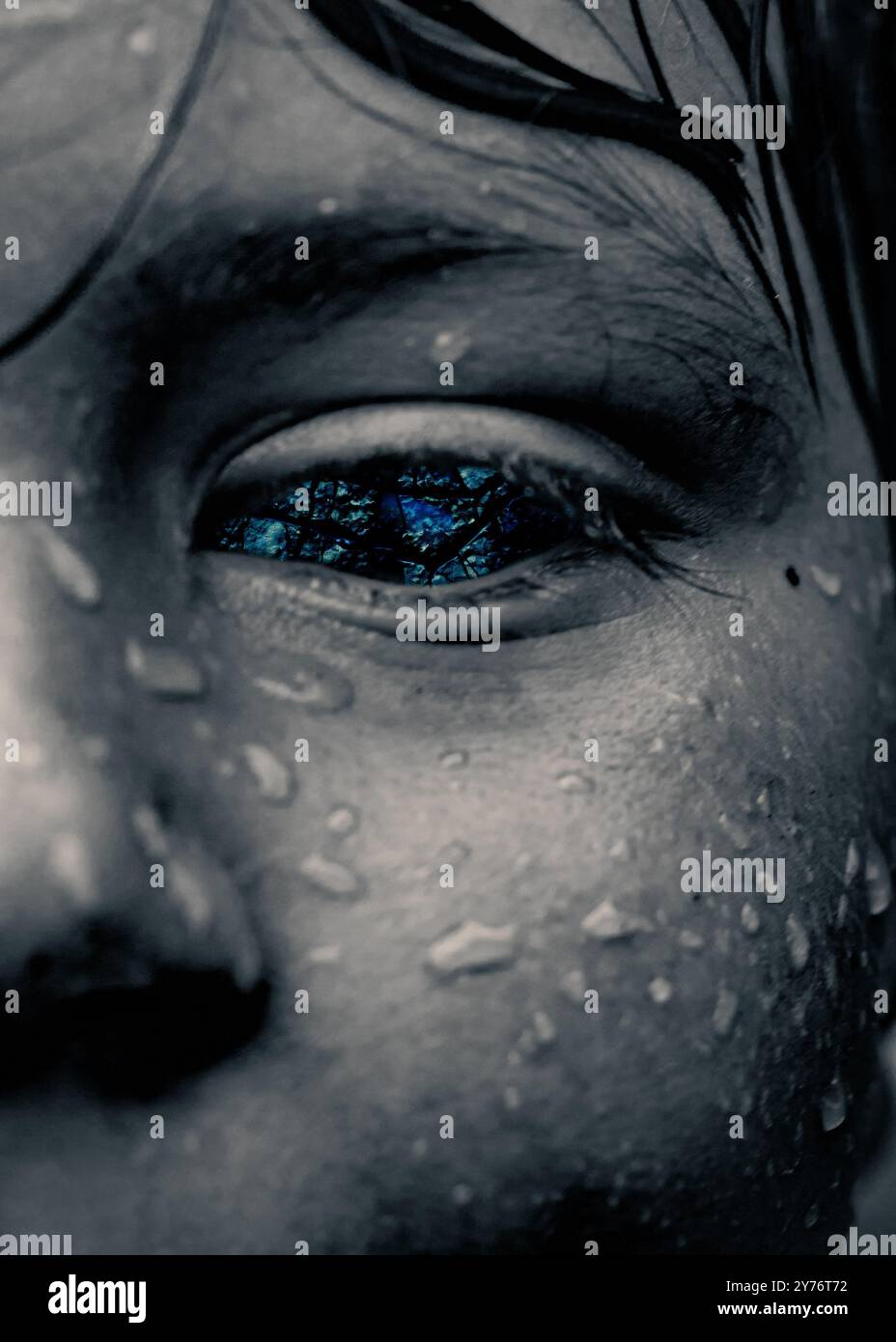black and white portrait of child with demonic blue eye Stock Photo - Alamy