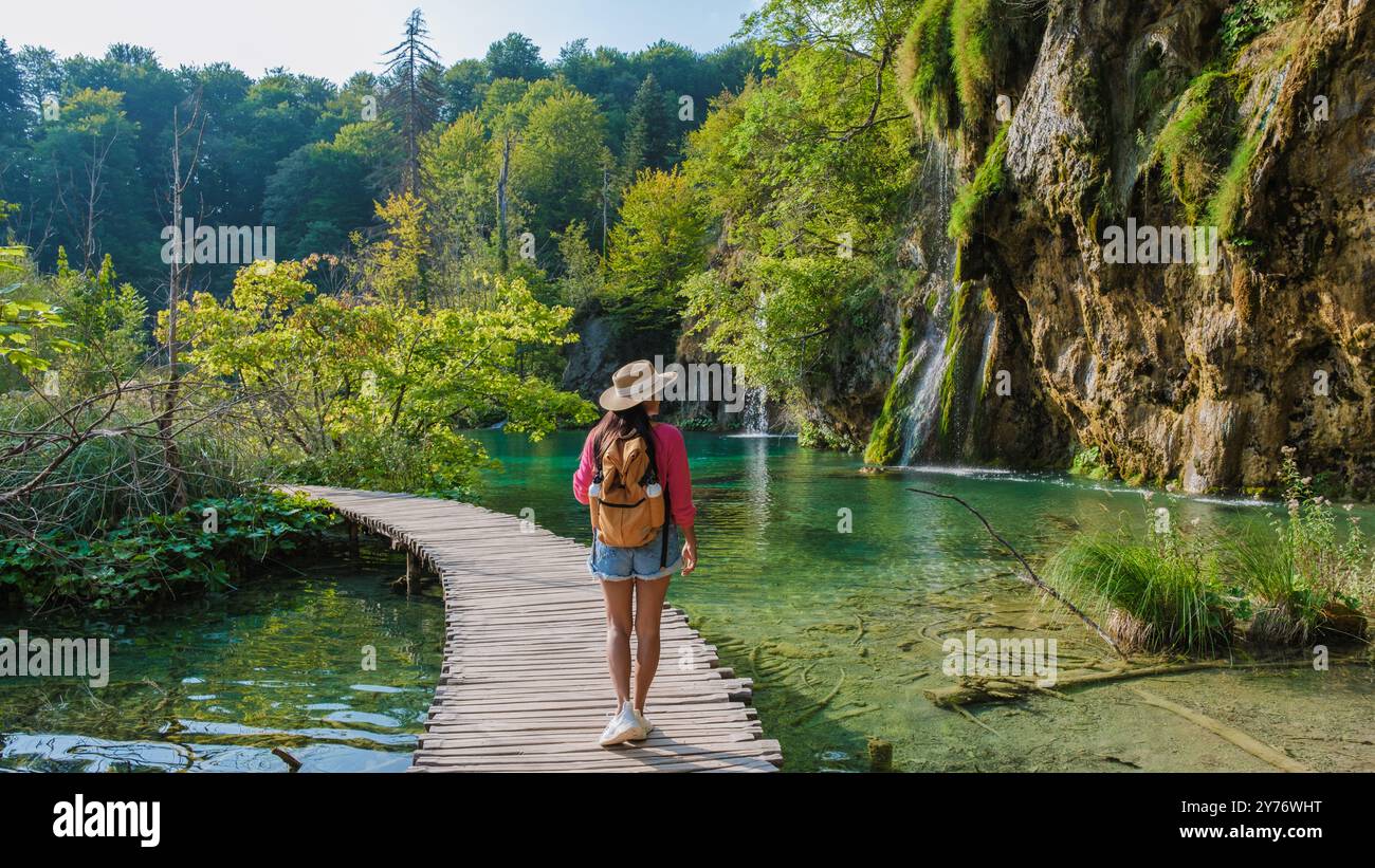 Wandering along the wooden pathways of Plitvice Lakes, a visitor enjoys ...