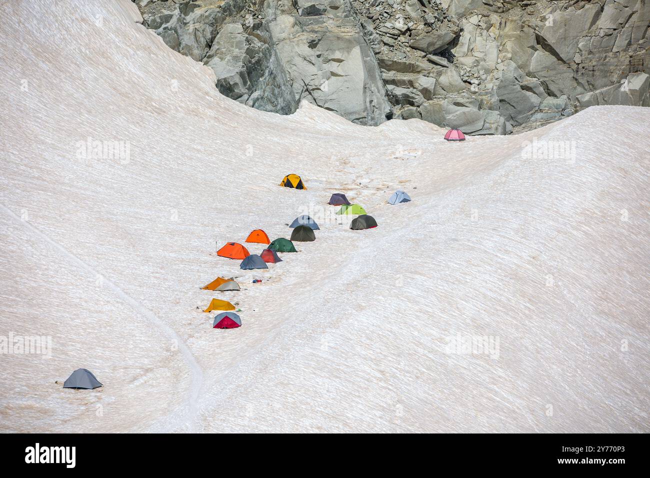 view of a large group of colorful tents in the snow in the alps in the ...
