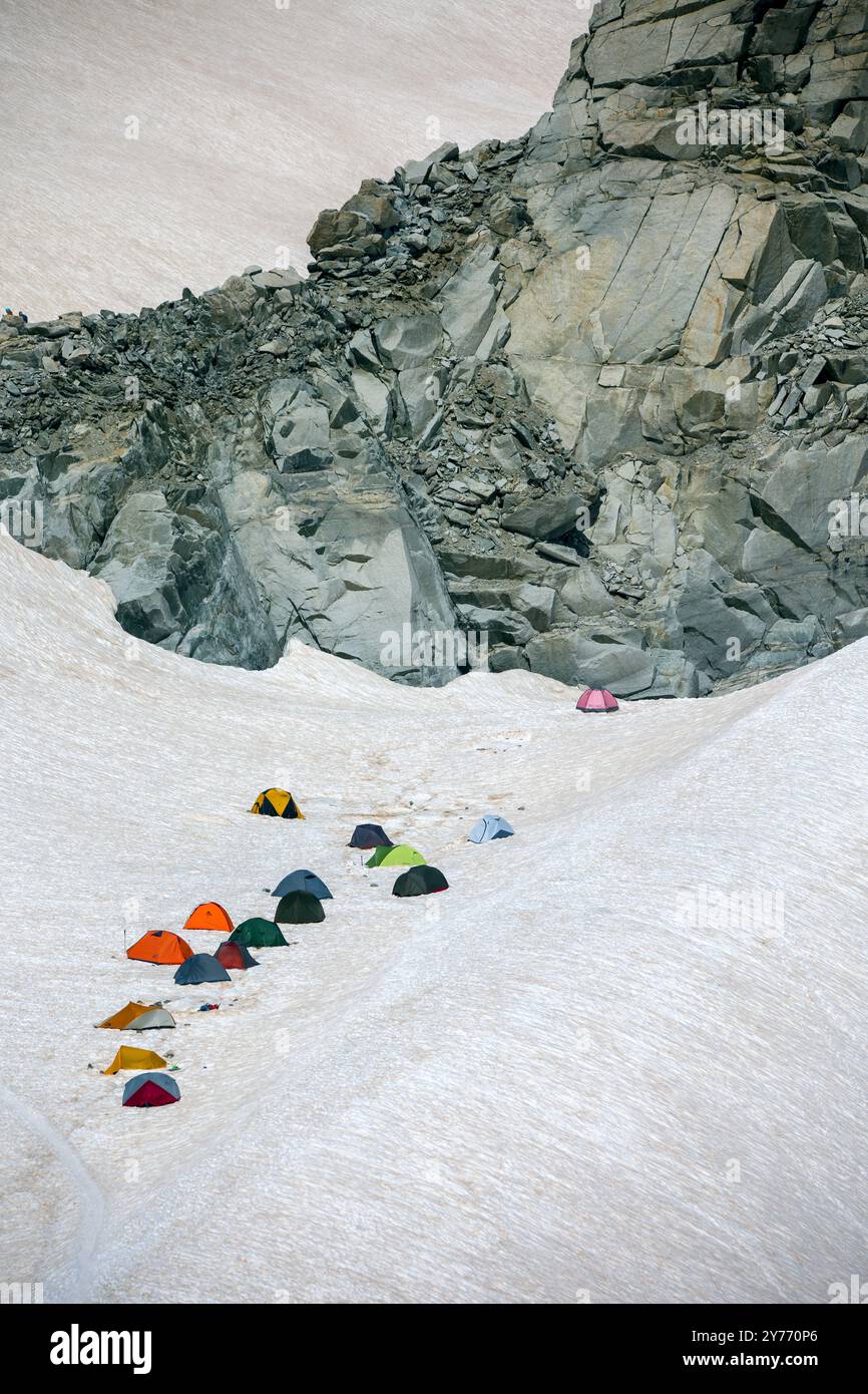 view of a large group of colorful tents in the snow in the alps in the ...