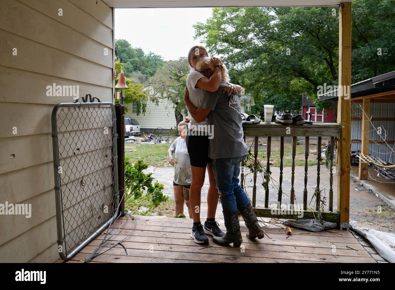 Ashlie Salliotte, left, hugs Janet Sams, right, at Sams' flood-damaged ...