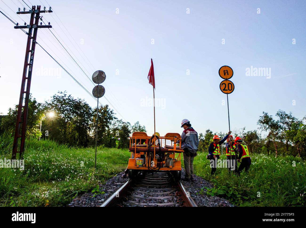 Maintenance workers from the State Railway of Thailand are seen ...