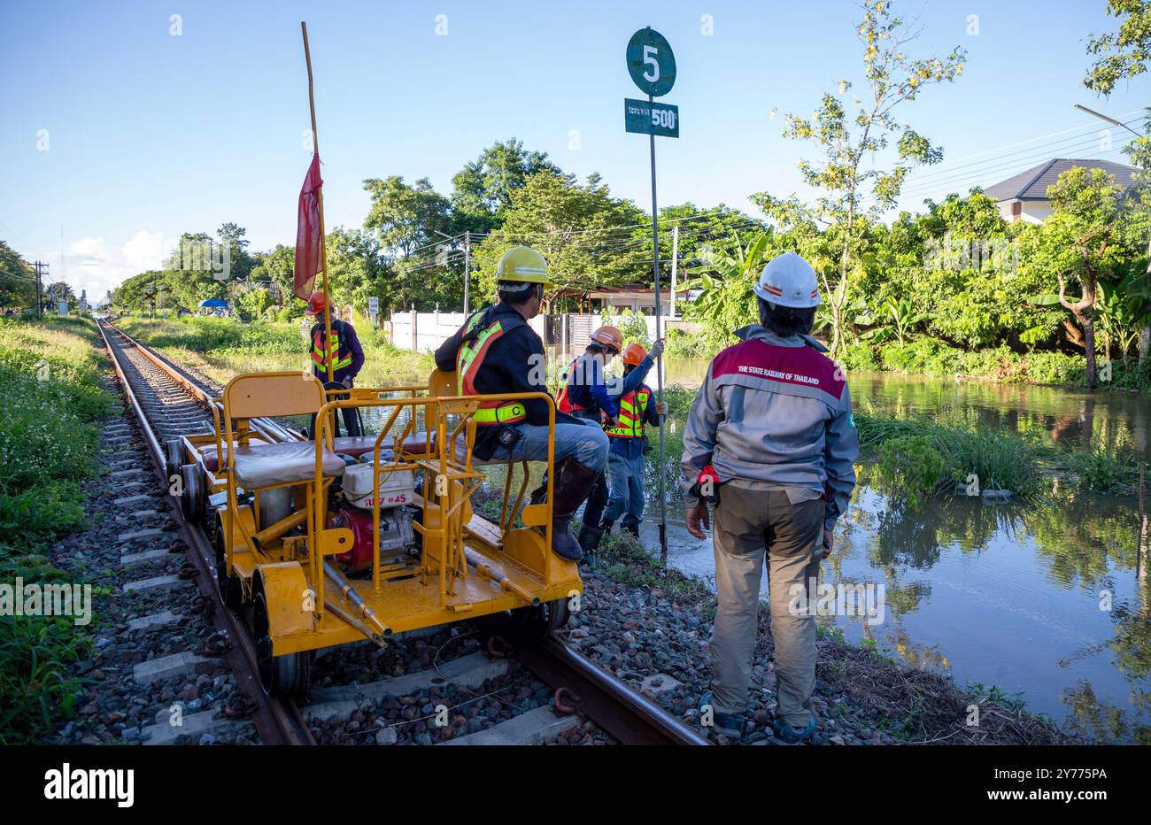 Maintenance workers from the State Railway of Thailand are seen ...