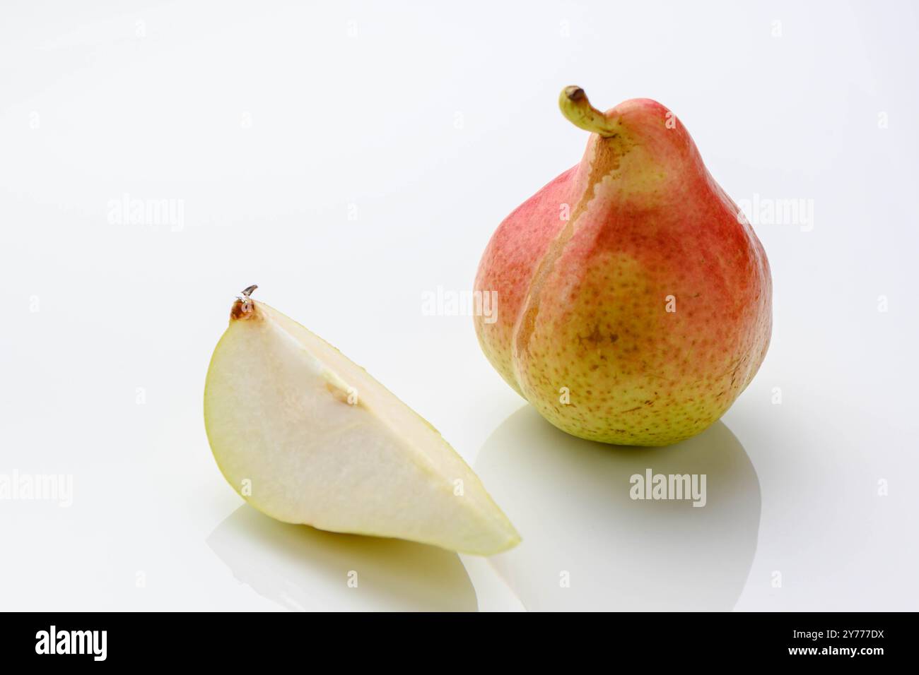Whole and half cut pears on white background Stock Photo - Alamy