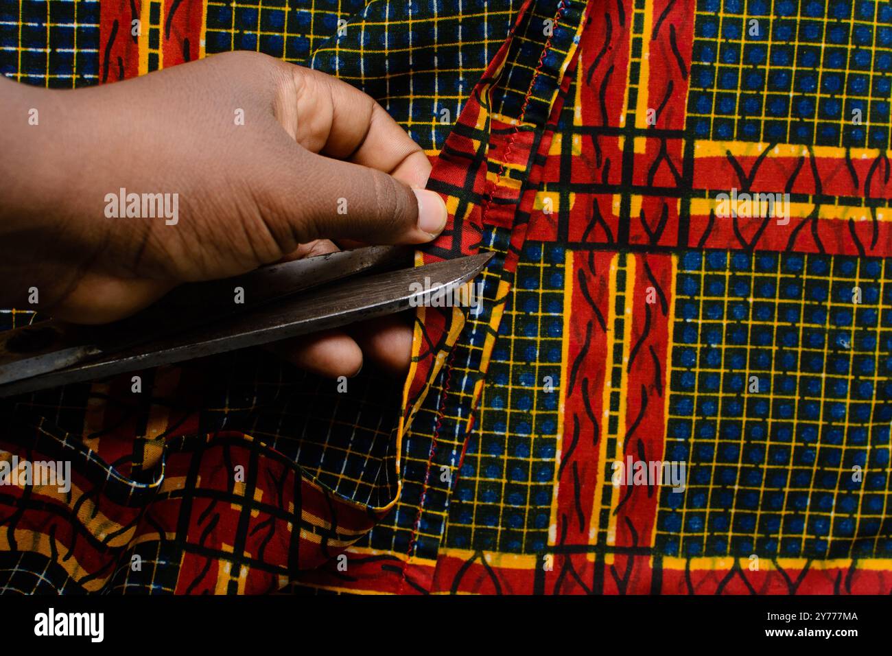 top view of cutting ankara fabric with scissors , flatlay of nigerian ...
