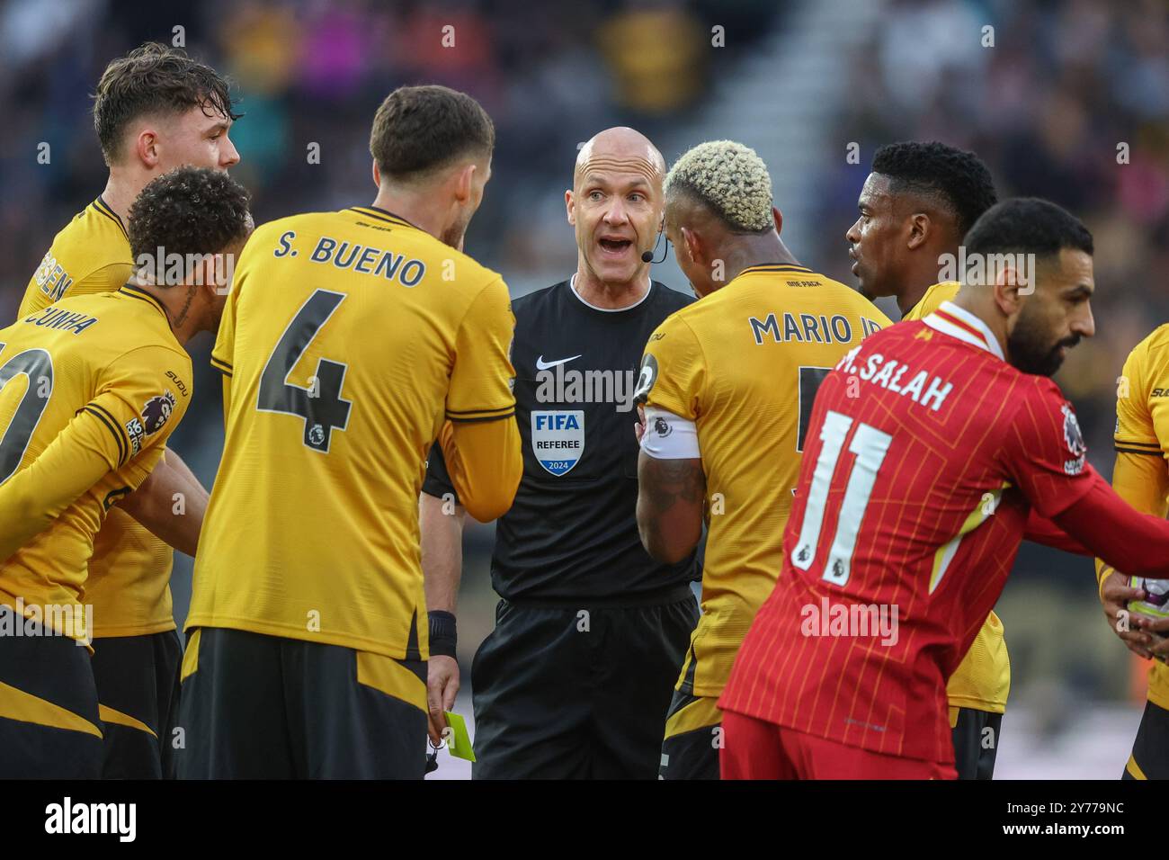 Referee Anthony Taylor speaks to the Wolves players after a foul on ...
