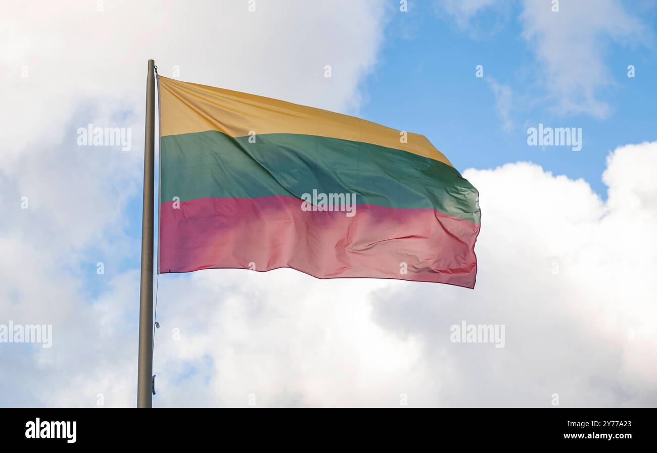 Flag of Lithuania flying in the wind with a blue sky background ...