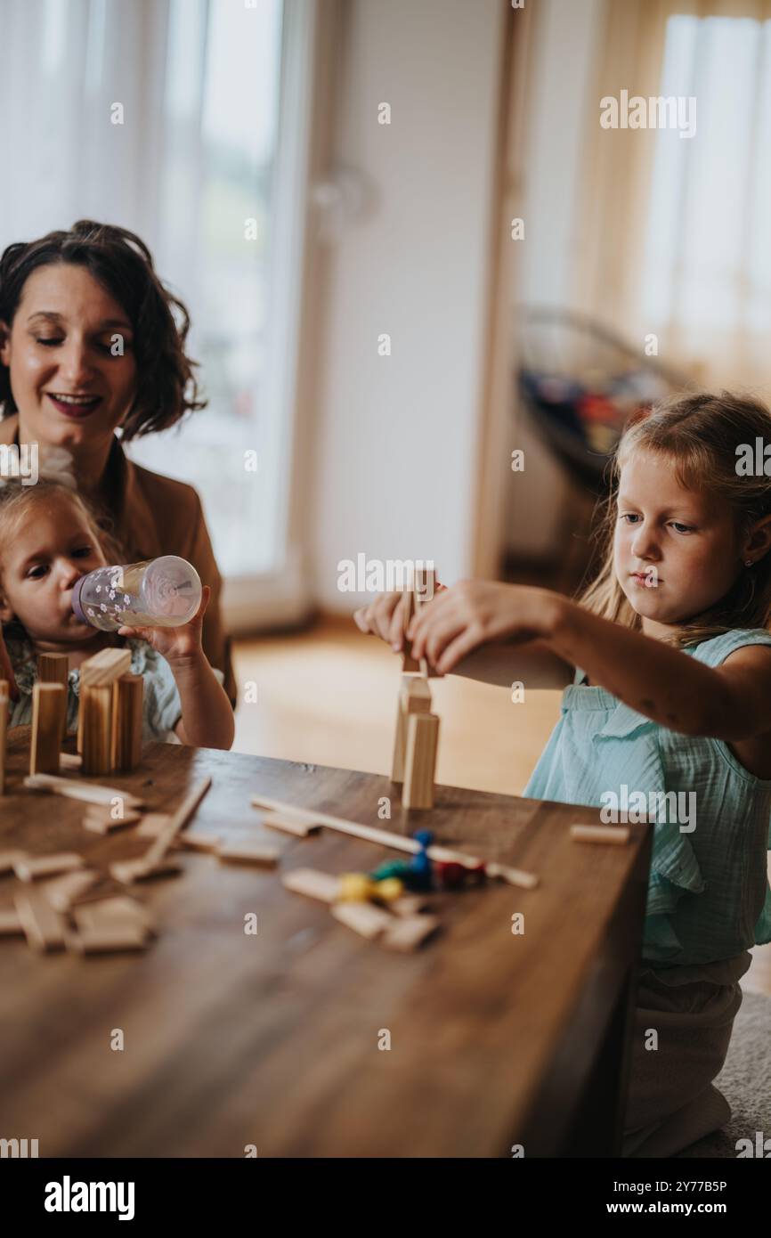 Mother and daughters enjoying quality time with wooden blocks Stock ...