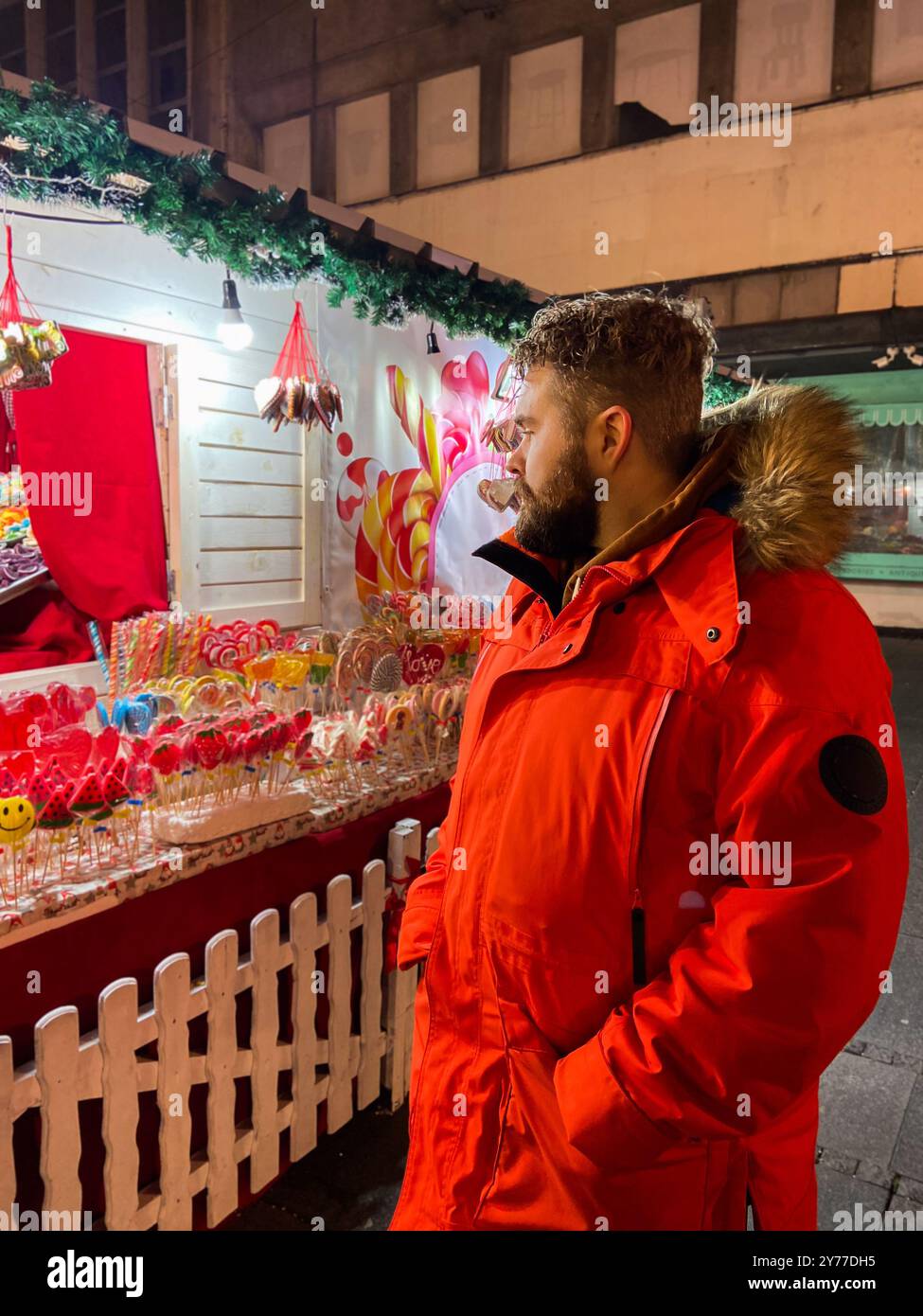 Handsome millennial man model with a hairstyle in winter red jacket ...