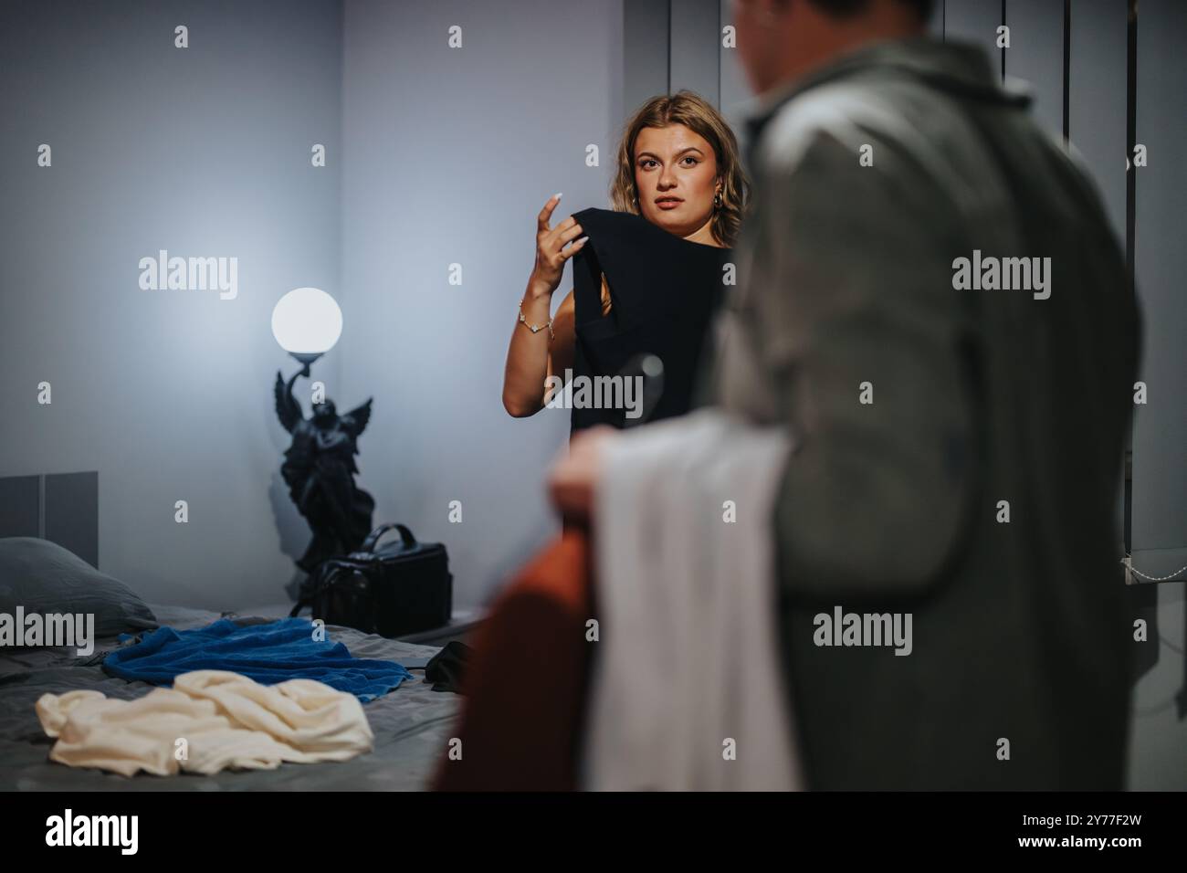 Couple preparing outfits for an exciting night out together Stock Photo ...