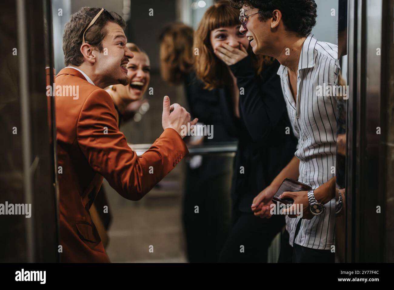 Group of friends laughing and bonding in an elevator Stock Photo - Alamy