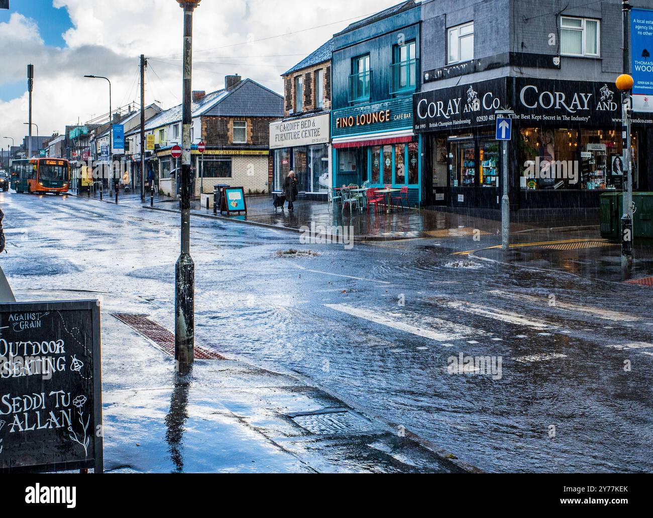 Overflowing Manhole covers during a flash flood in a UK High Street ...
