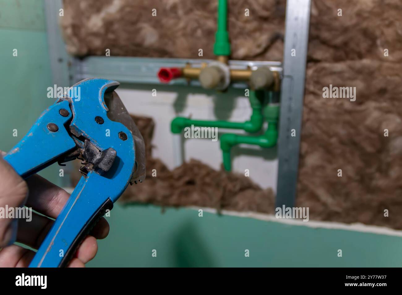 Tool for cutting plastic pipes in the hand of an adult man close-up ...
