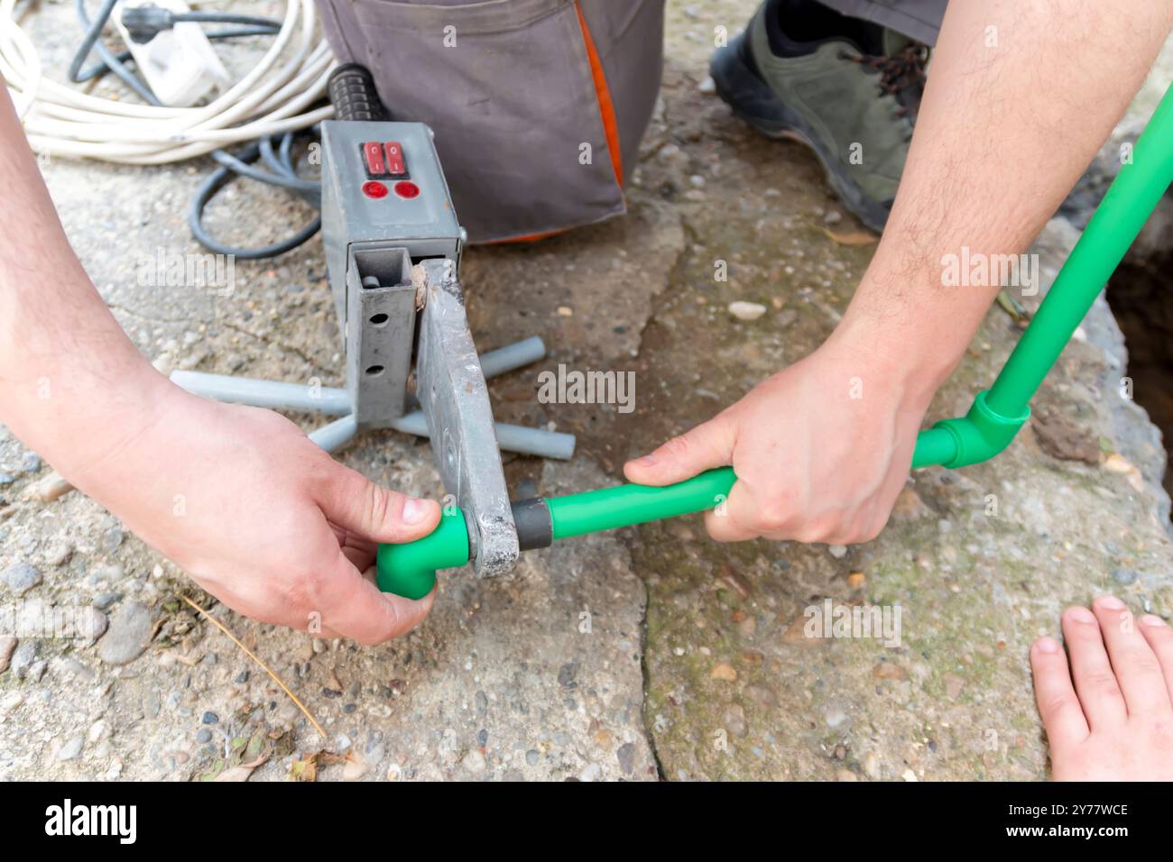 Plumber welding plastic pipes. Installation of plastic pipes welder ...