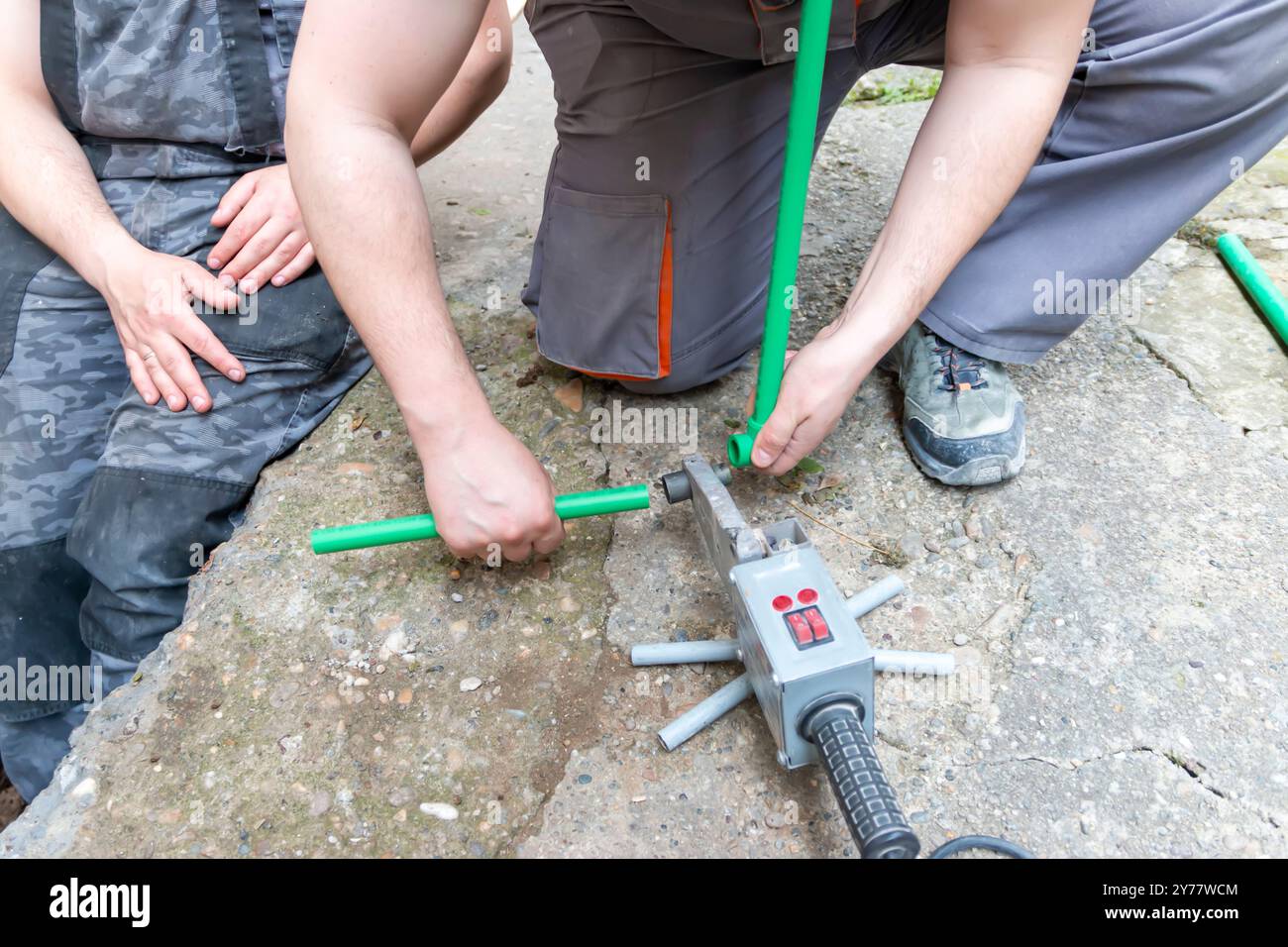 Plumber welding plastic pipes. Installation of plastic pipes welder ...