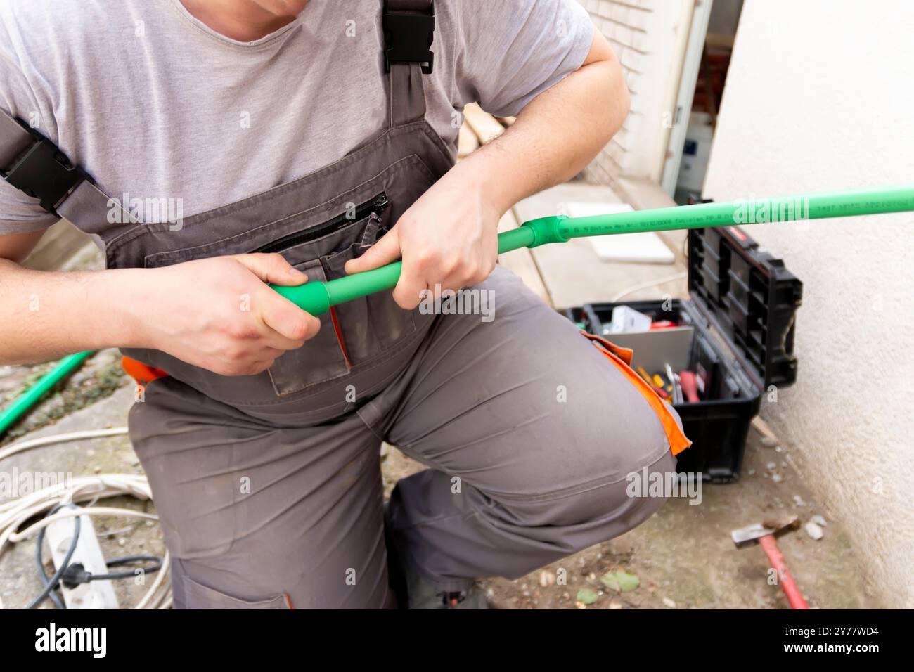 Plumber welding plastic pipes. Installation of plastic pipes welder ...