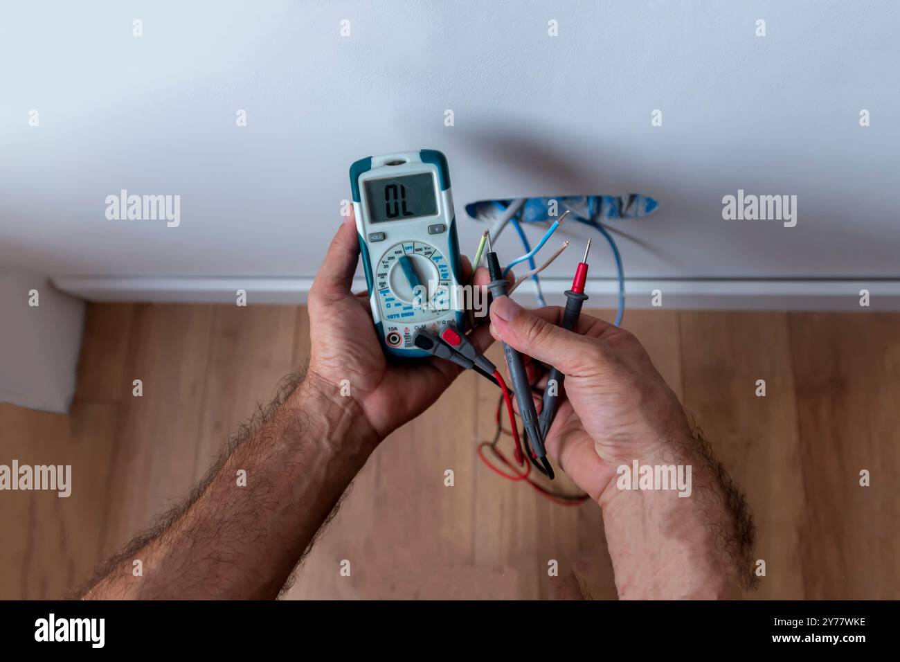Measuring the voltage in the socket with a professional digital multimeter. Process of ...