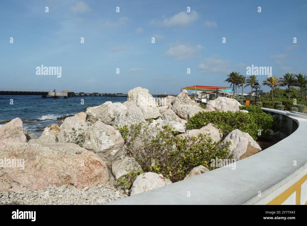 A contemporary promenade lined with white rocks graces the waterfront ...