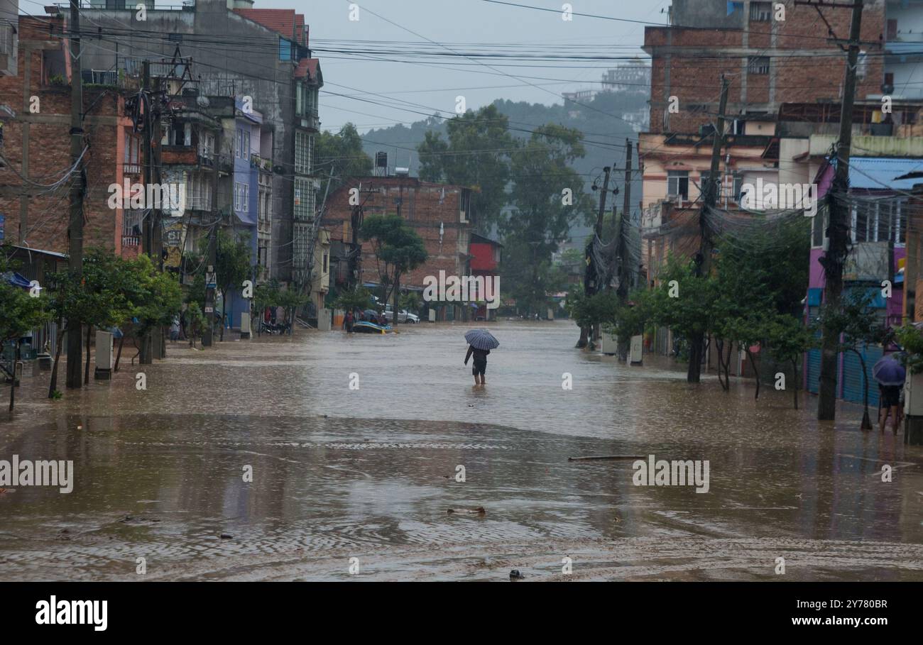 A man wades through flood waters after the Bagmati River overflowed ...