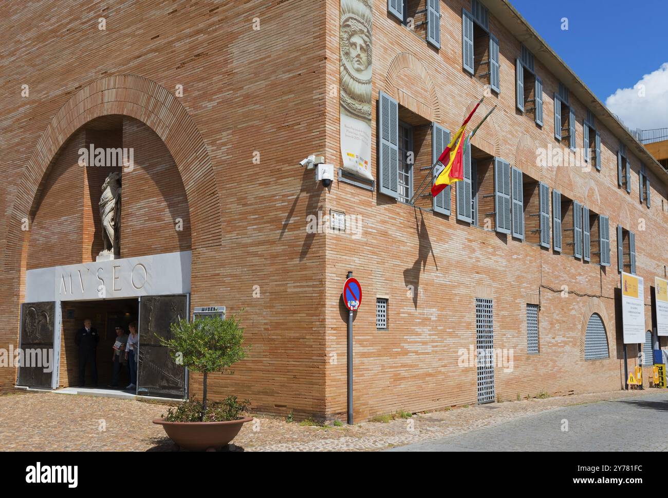 Red brick museum building with Spanish flag and sculptures at the ...