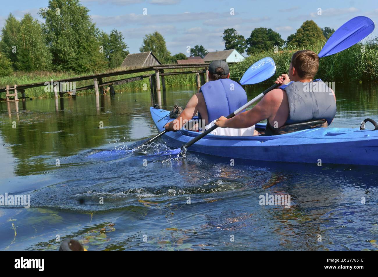 The fusion of two rowers, the two rowers in the blue kayak, the rowers ...