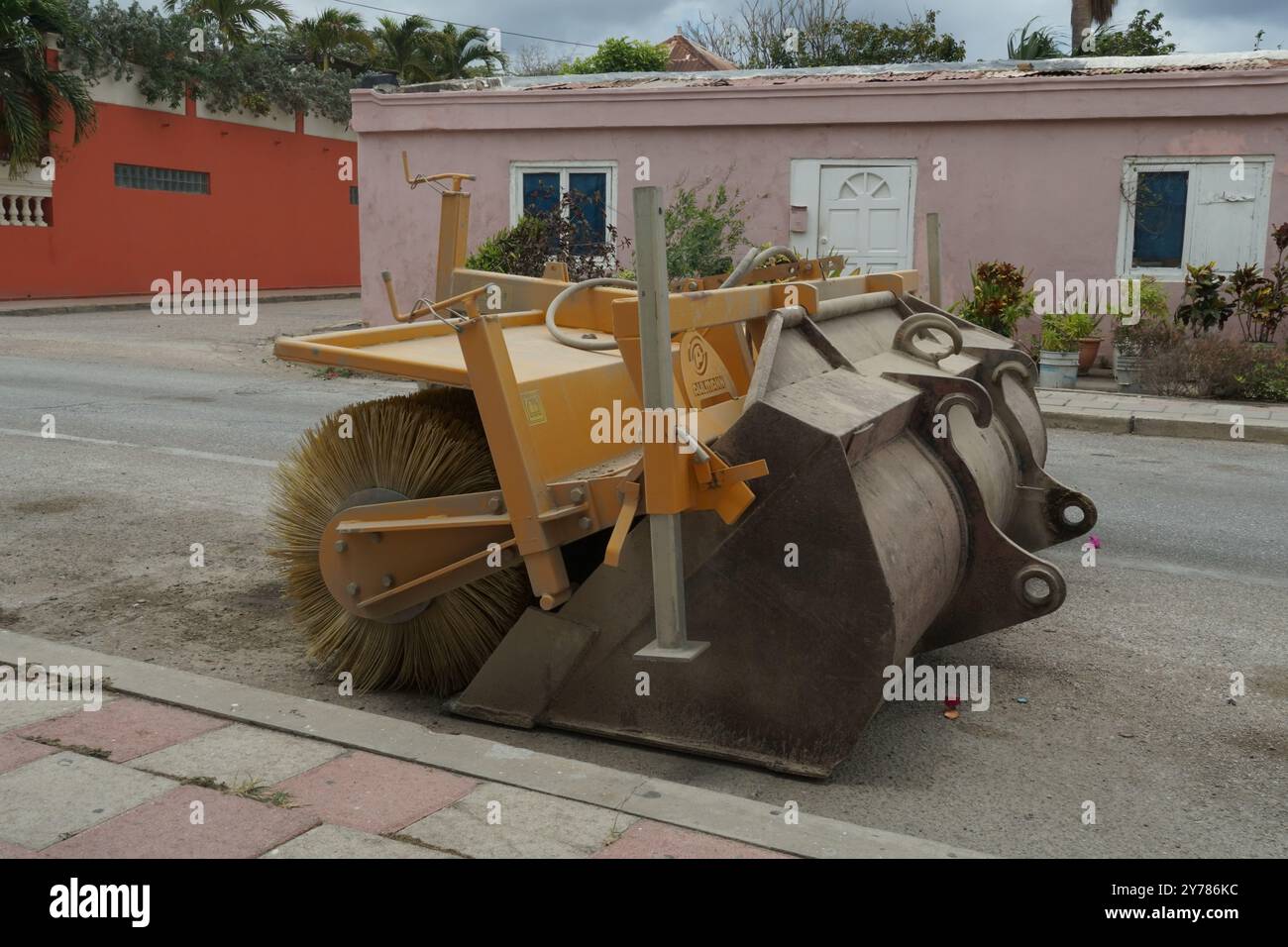 Broom for street sweeper in downtown district with colorful old ...