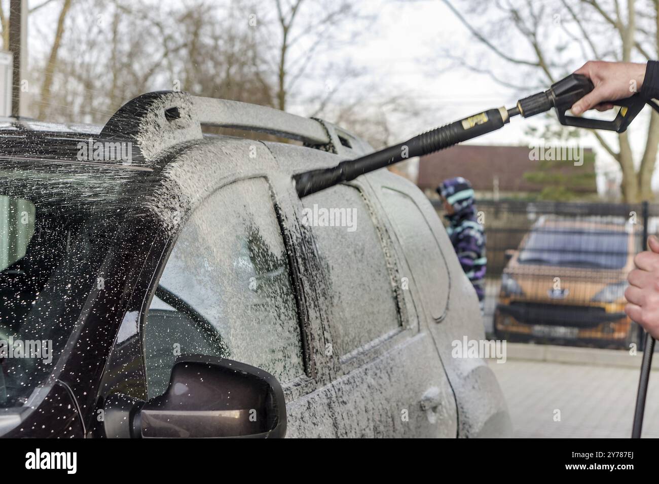 Kaliningrad, Russia, 2020, March 1: A man washes his car at a touchless ...