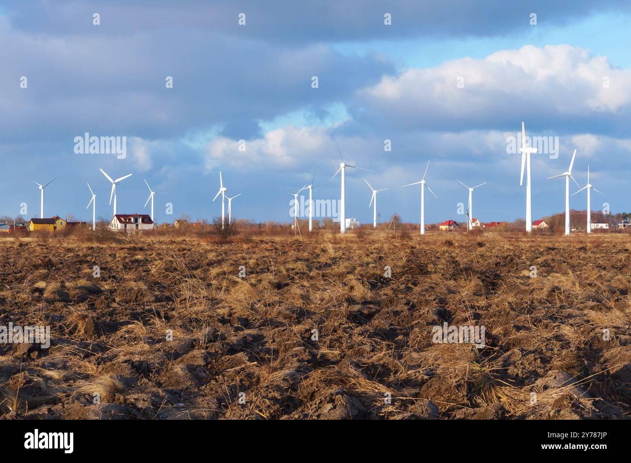 Wind farm in the field, freshly plowed field, agricultural land and ...
