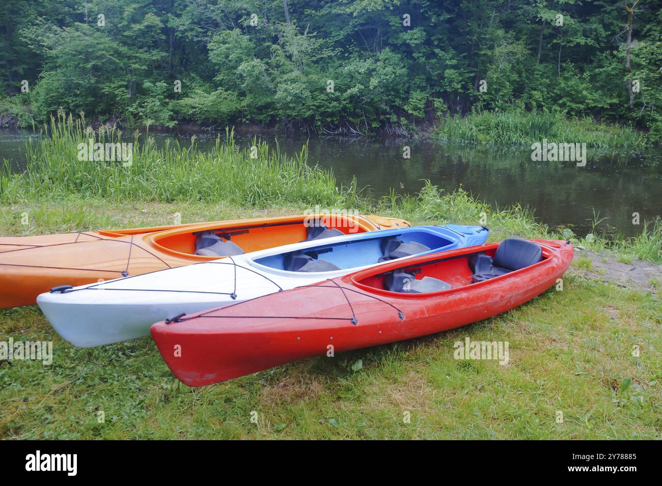 Four kayaks on the Bank of the river, sports kayaks on the shore of the ...