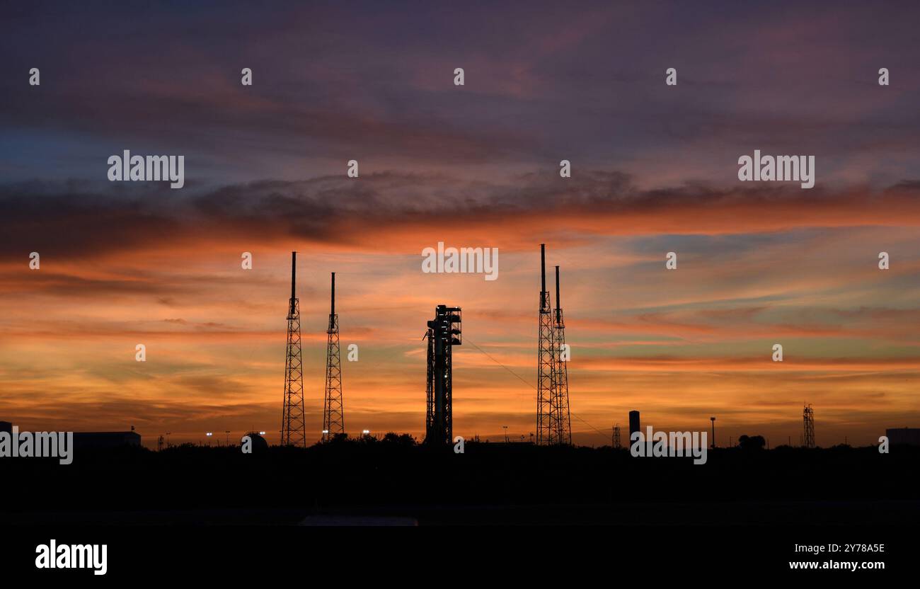 At dusk, a SpaceX Falcon 9 rocket is prepared to launch its Crew Dragon ...
