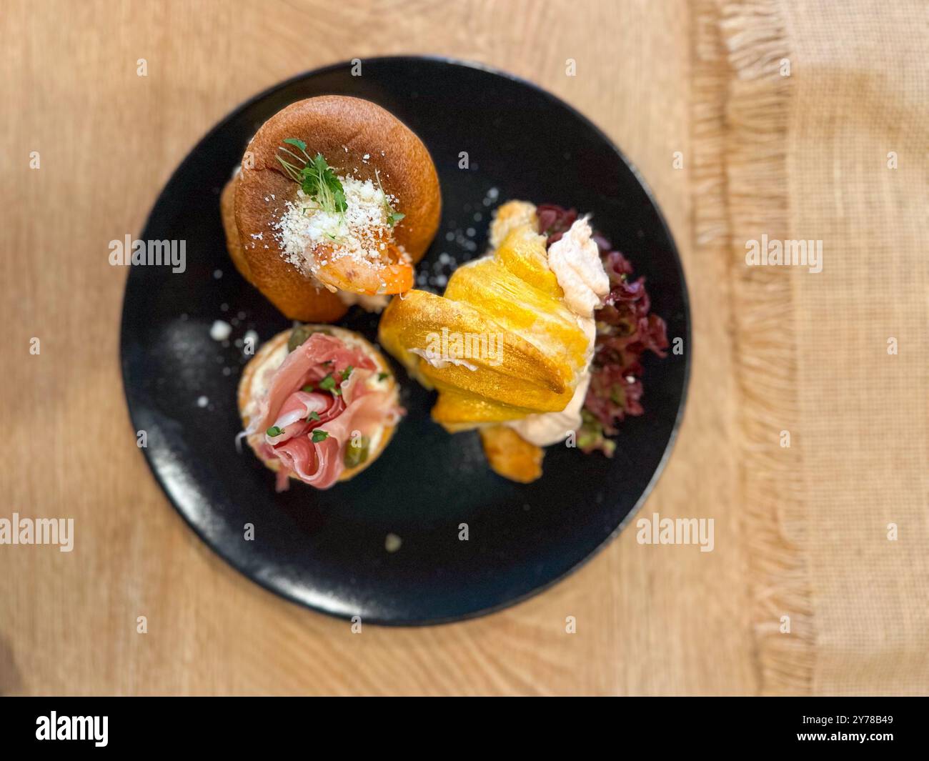 Gourmet appetizers elegantly arranged on black plates. Colorful ...