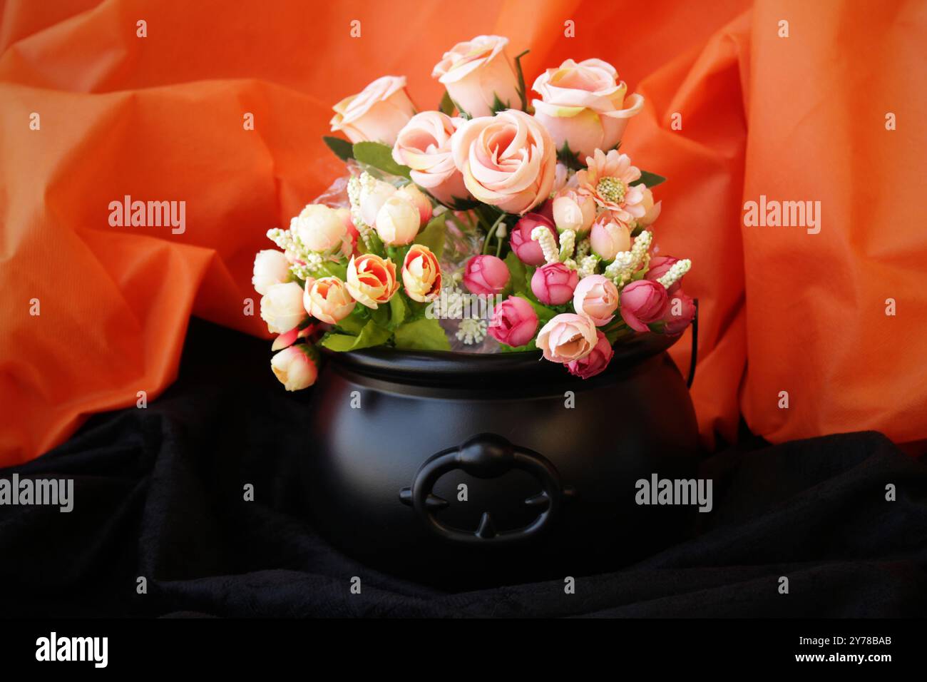 Black witch cauldron used as a vase of flowers on a Halloween ...