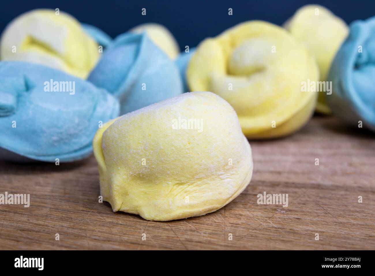 Cooking dumplings. Frozen, blue and yellow raw dumplings. Copy space ...