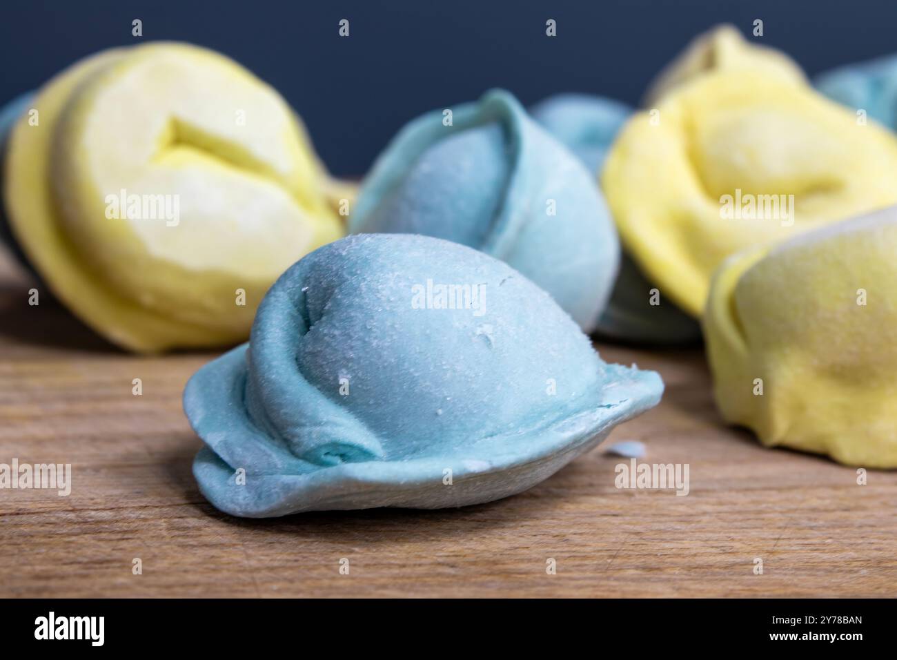 Cooking dumplings. Frozen, blue and yellow raw dumplings. Copy space ...