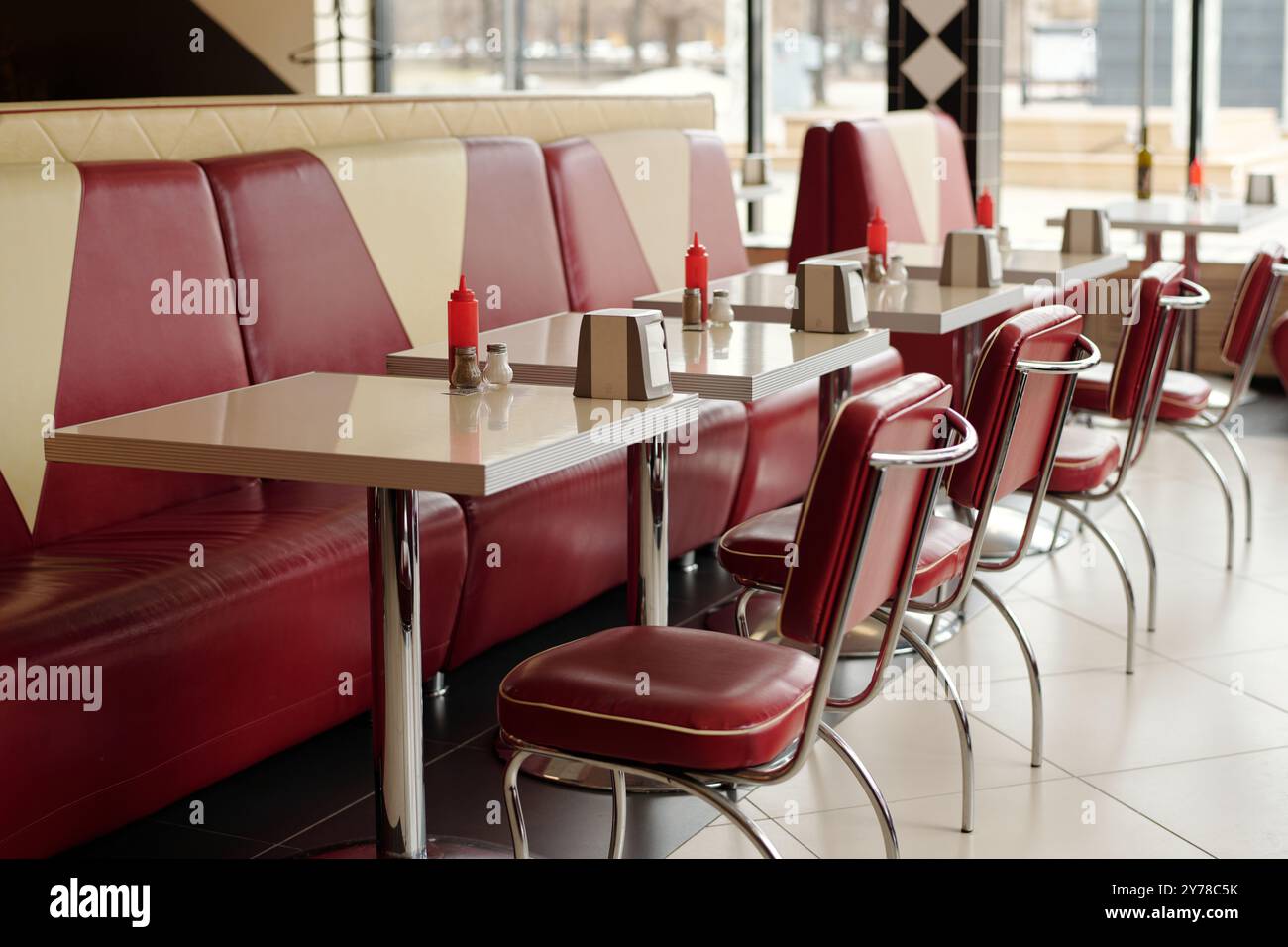 Interior of retro-style American diner with red leather booths and ...