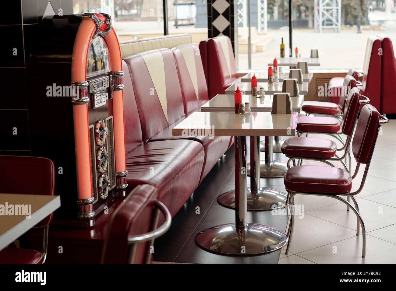 Vintage diner featuring red leather booths, chrome tables, and an old ...