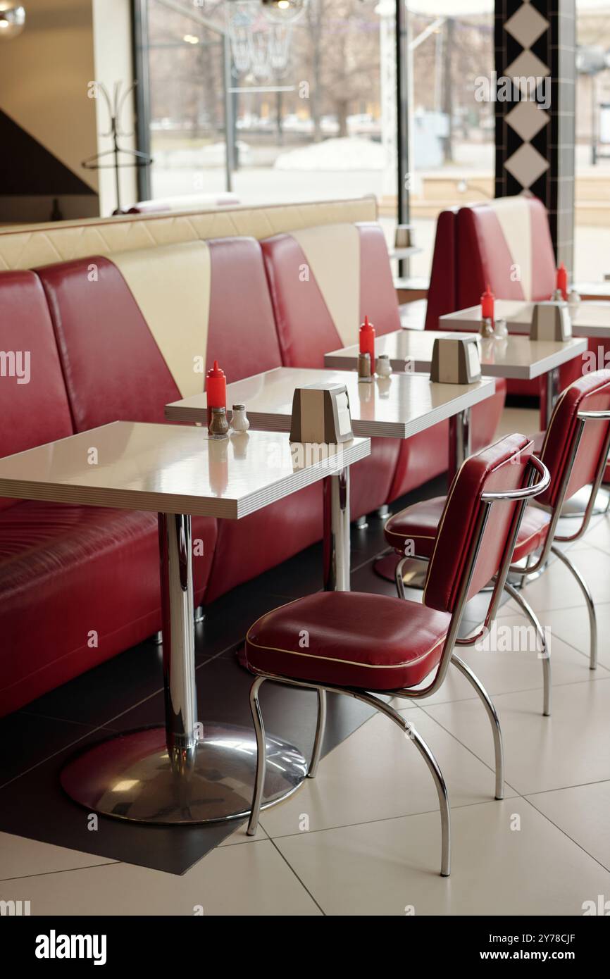 Classic retro diner setting featuring red booths and silver tables ...