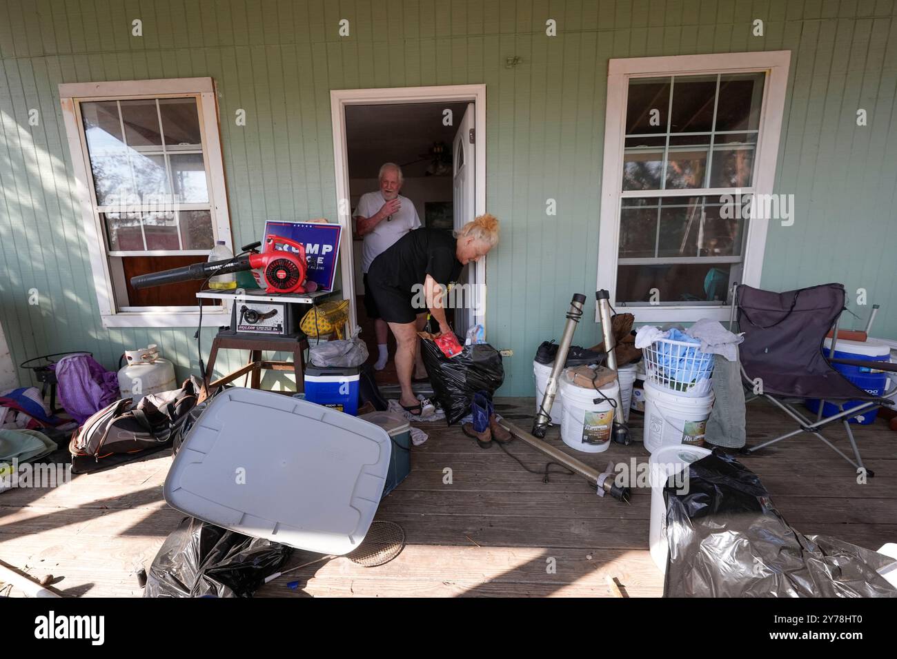 Pam Keen cleans up after their house took on water from the storm surge ...