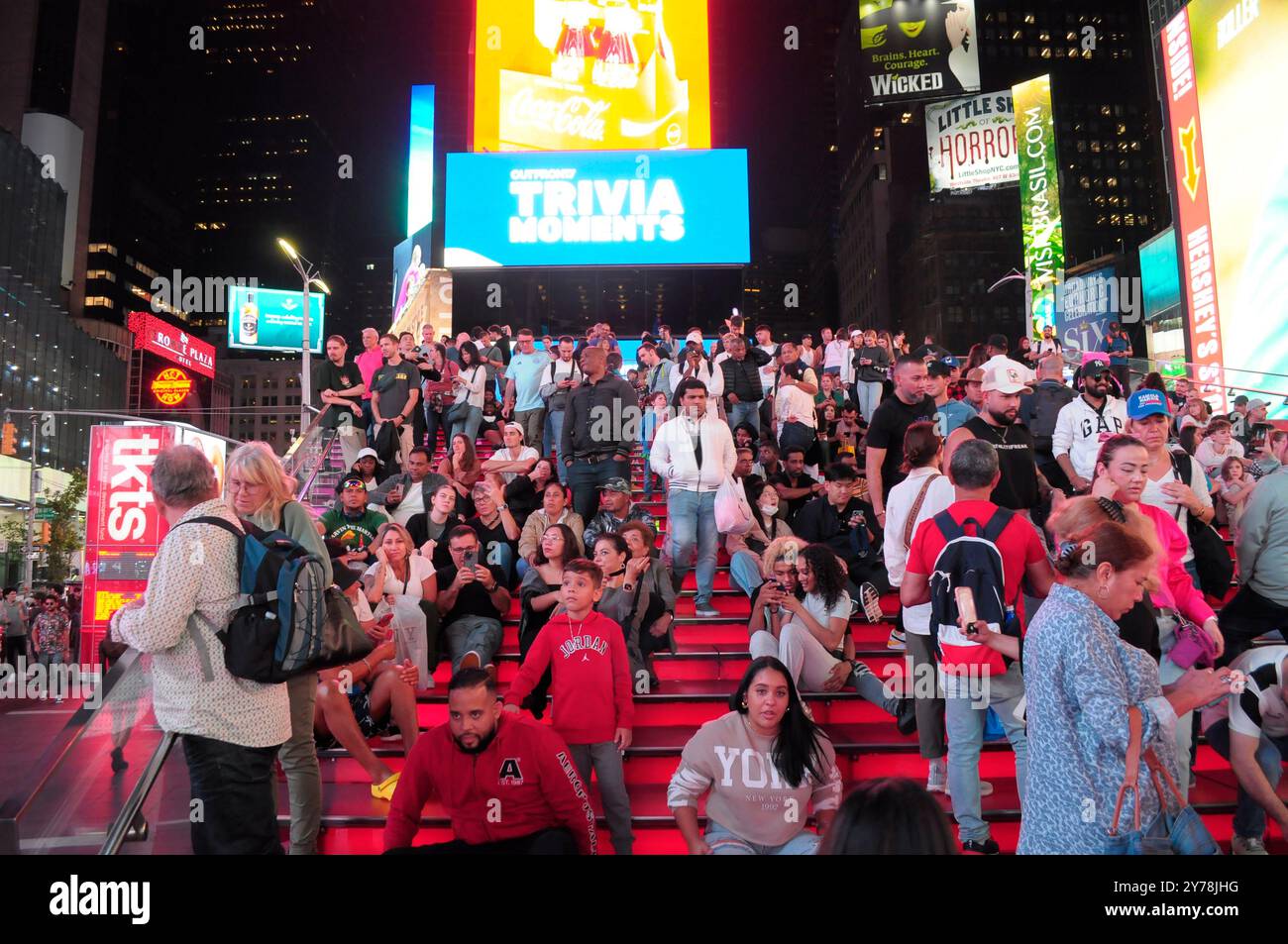 People sit on the red staircase in Times Square, Manhattan, New York ...