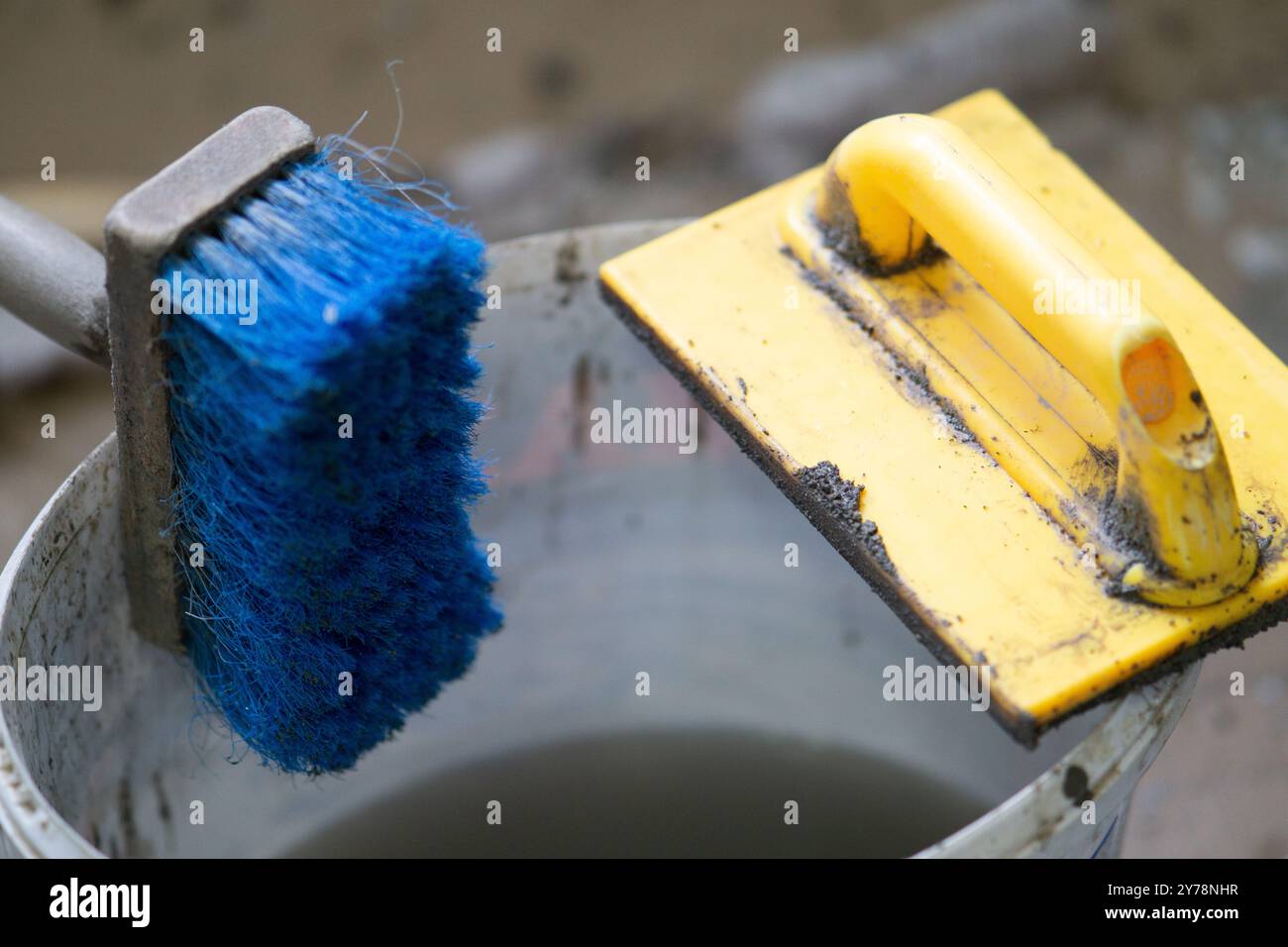 Brush and trowel for puster on a construction plastic bucket Stock ...