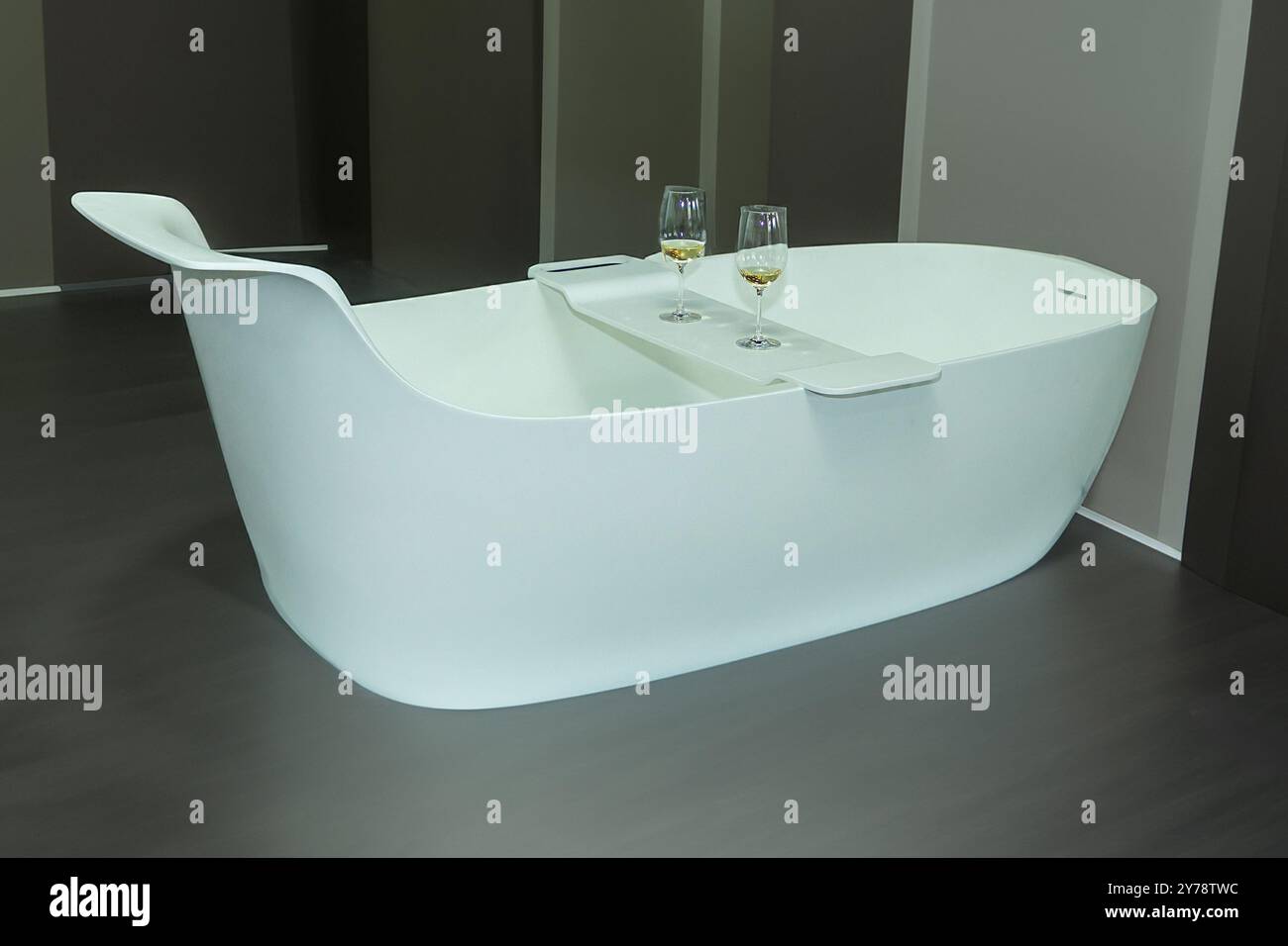 Empty bath tub in the middle of the bathroom interior with serving ...